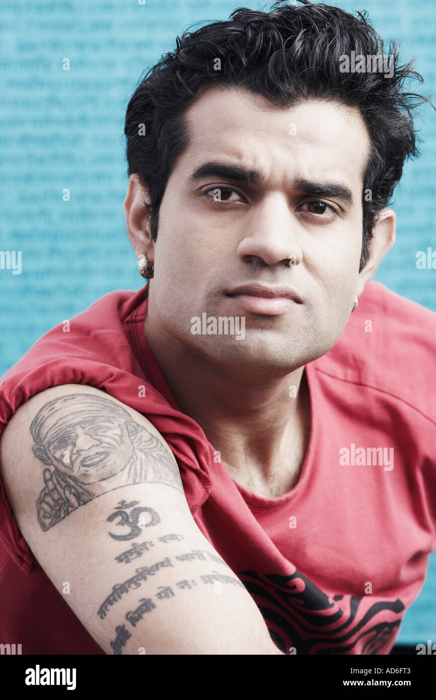 Portrait of a young man with tattoos on his arm Stock Photo - Alamy