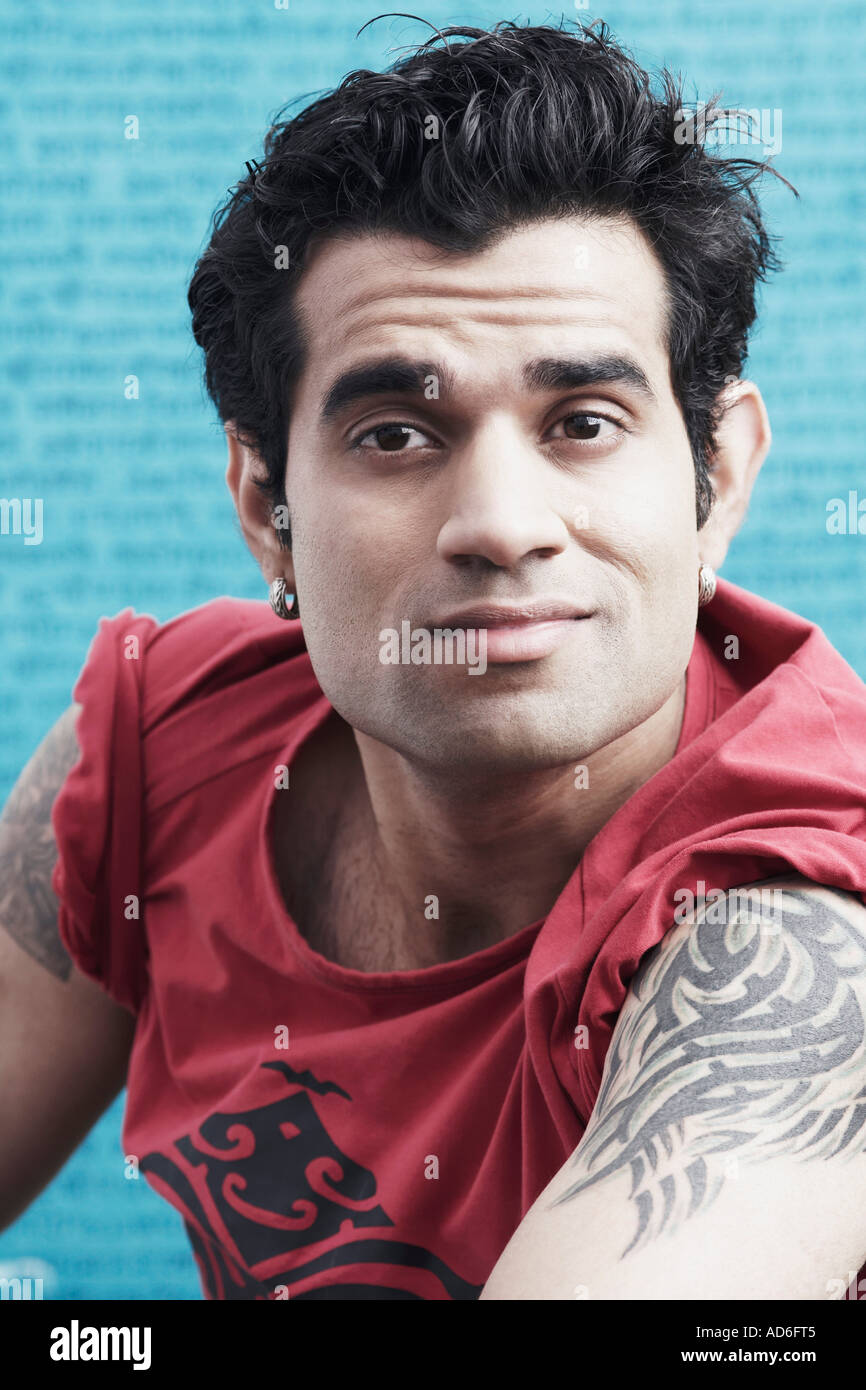 Portrait of a young man with tattoos on his arm Stock Photo - Alamy