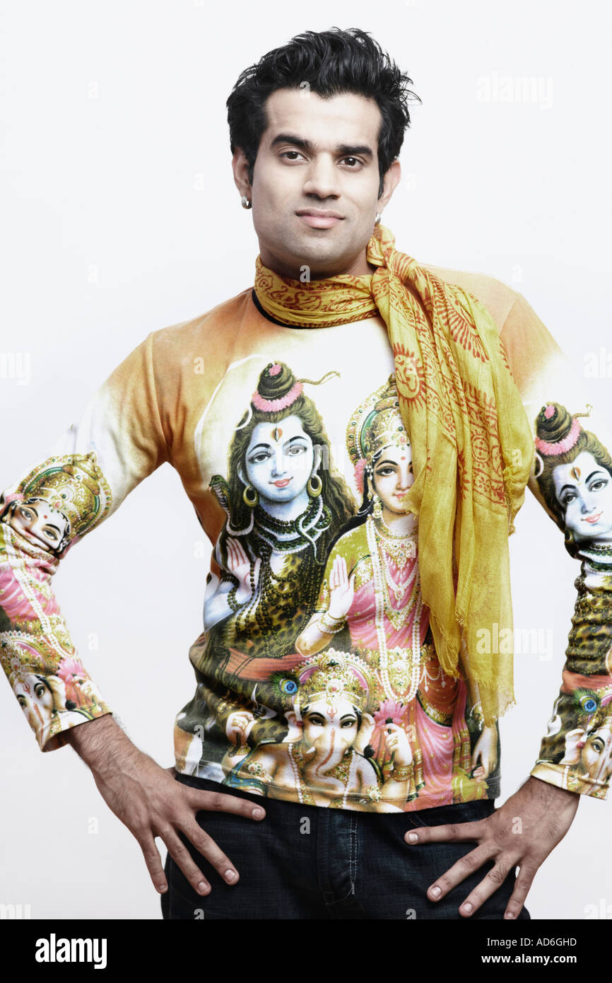 Portrait of a young man standing with arms akimbo Stock Photo - Alamy