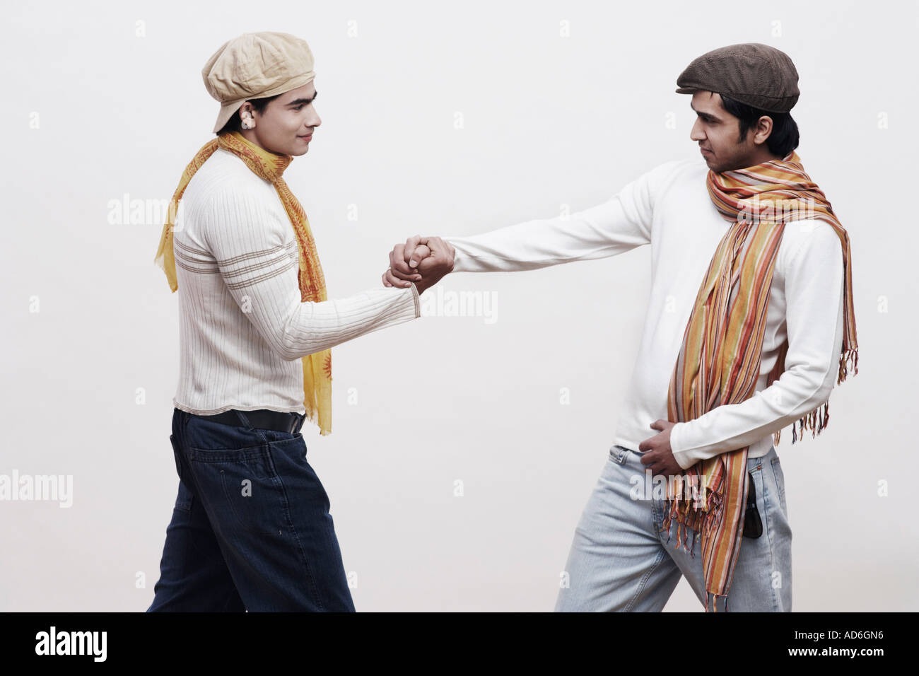 Two young men shaking hands Stock Photo - Alamy