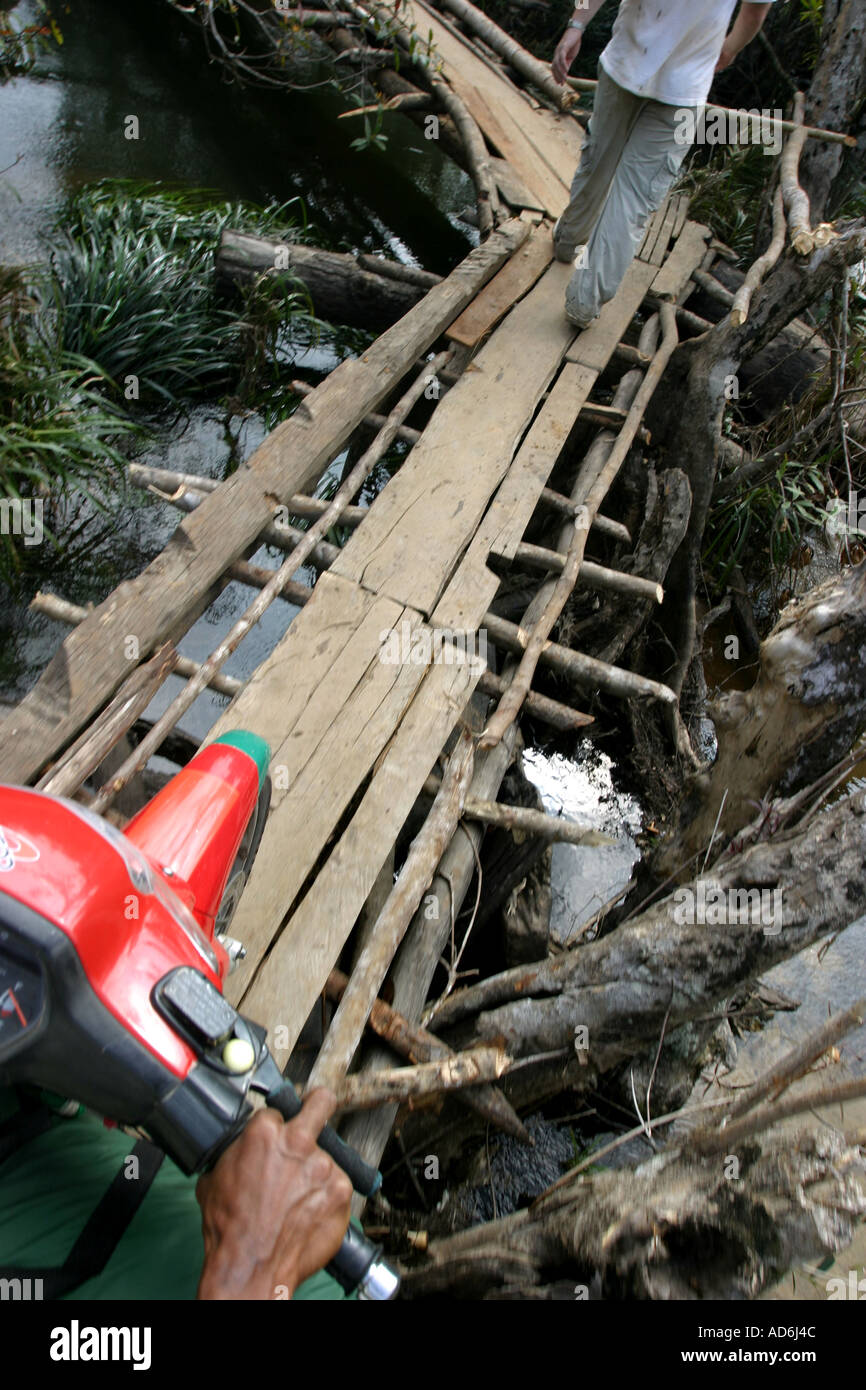 A rickety wooden bridge is tricky to negotiate in cambodia s remote and ...