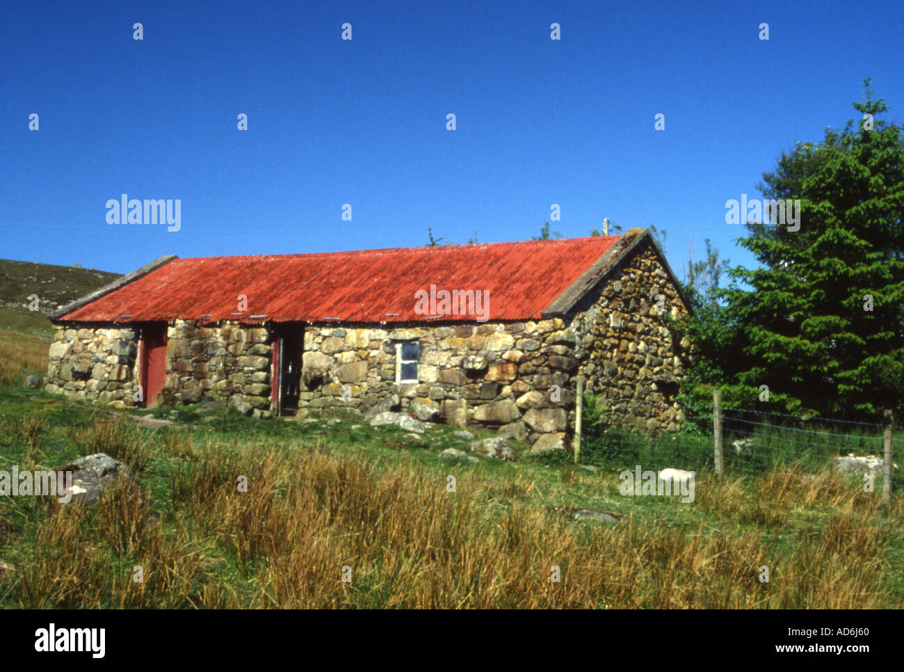 Highland bothy with stone walls and red roof Scotland UK Stock Photo ...