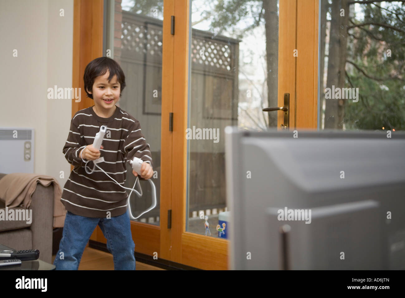 Little boy having a blast of fun, playing with the popular wireless ...
