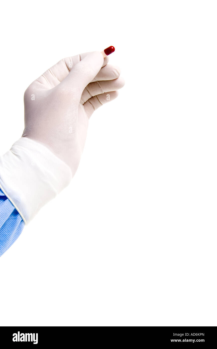 gloved hand giving pill Stock Photo - Alamy