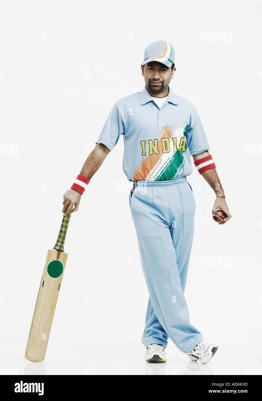 Portrait of a young man holding a cricket bat and a cricket ball Stock ...