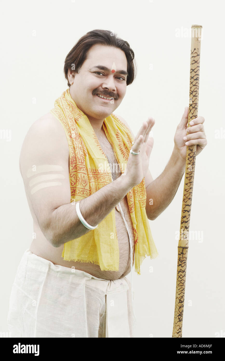 Portrait of a priest holding a stick Stock Photo - Alamy