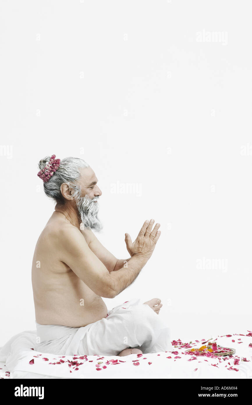 Side profile of a priest sitting in a prayer position Stock Photo - Alamy