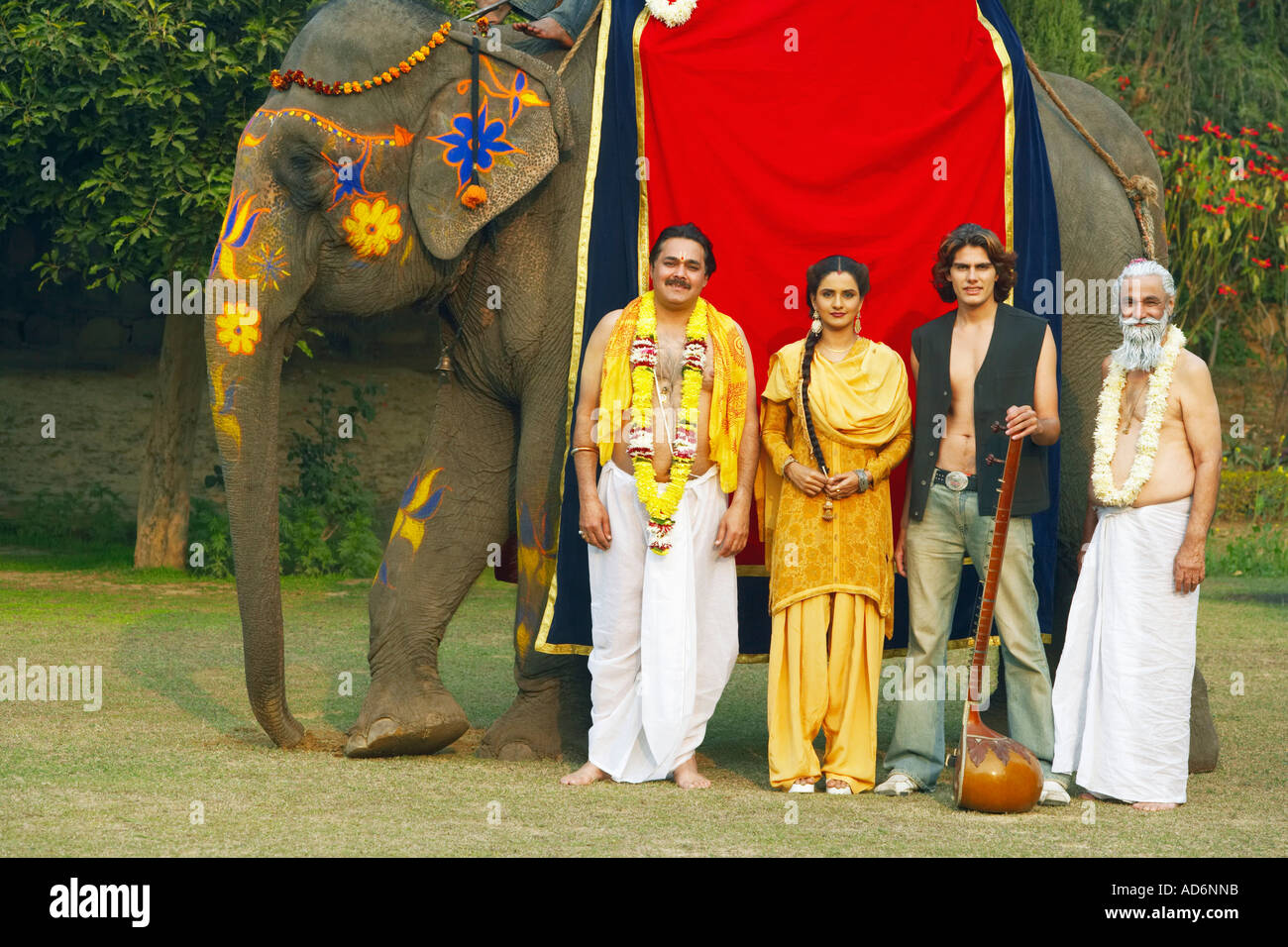 Group of people standing beside an elephant Stock Photo - Alamy