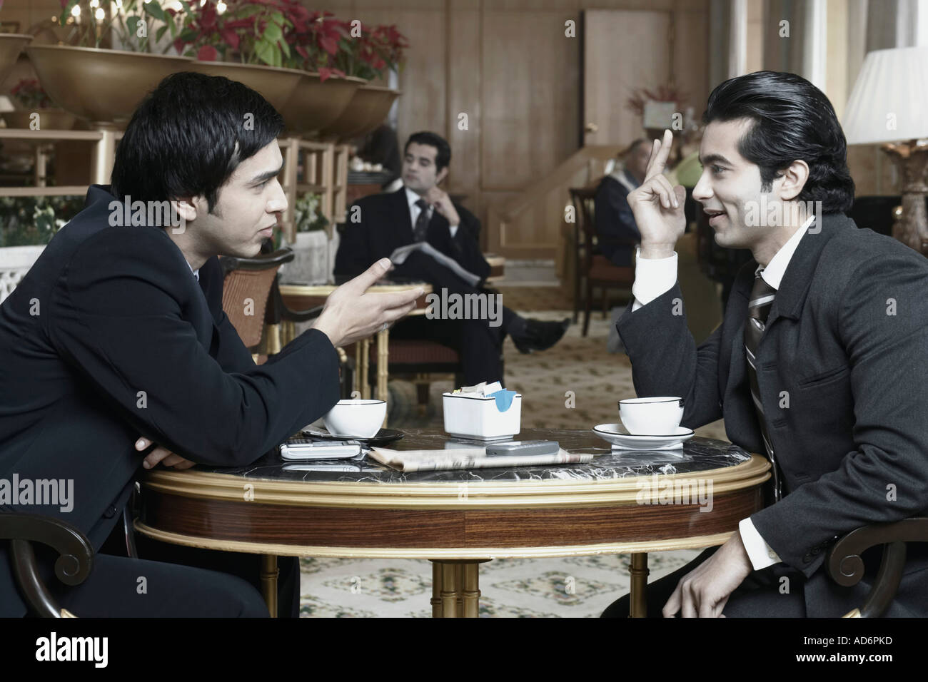 Side profile of two businessmen talking Stock Photo - Alamy