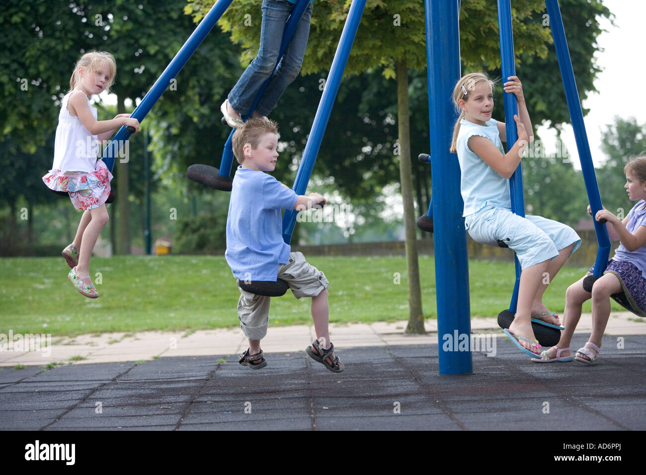 Children at a swing at the playground Stock Photo - Alamy
