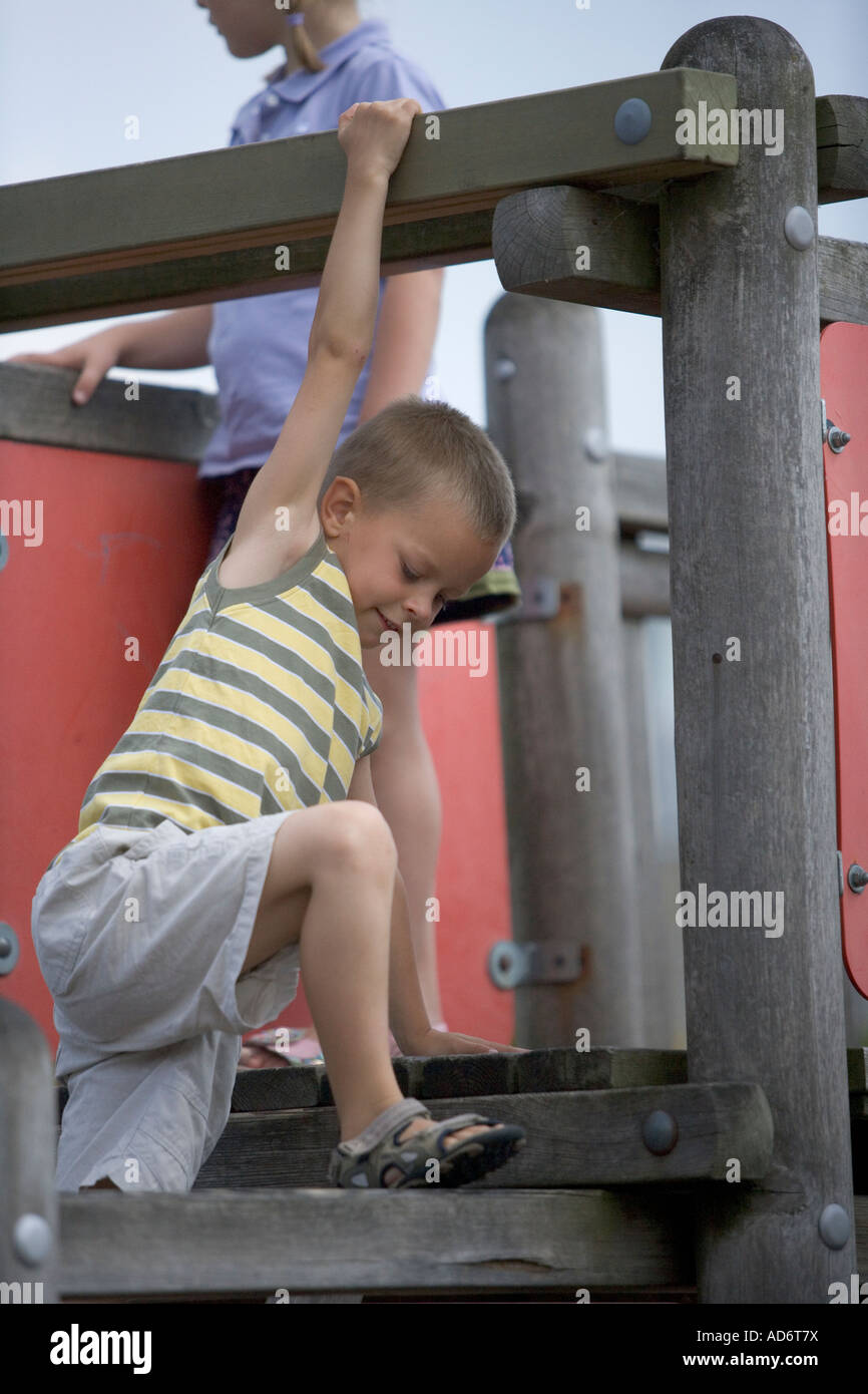 Boy at the end of a climbing pole at the playground Stock Photo - Alamy