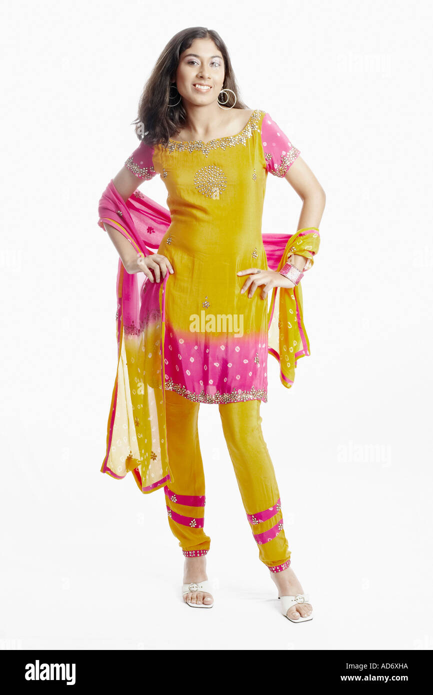 Portrait of a young woman standing with arms akimbo Stock Photo - Alamy