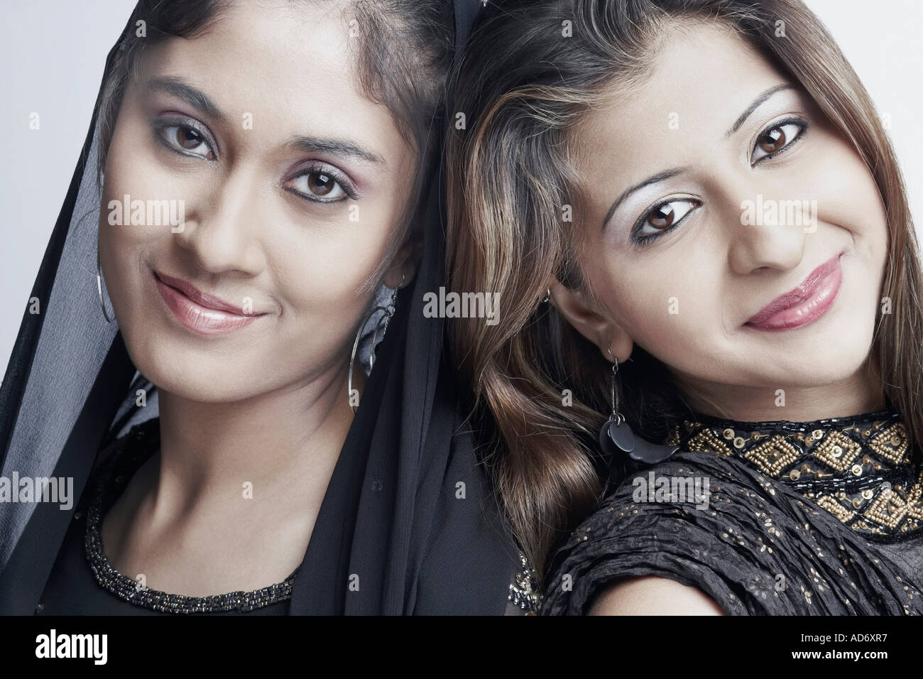 Portrait of two young women smirking Stock Photo - Alamy