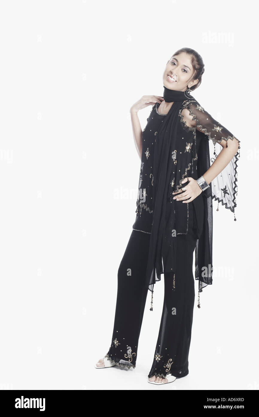 Portrait of a young woman standing with arms akimbo Stock Photo - Alamy