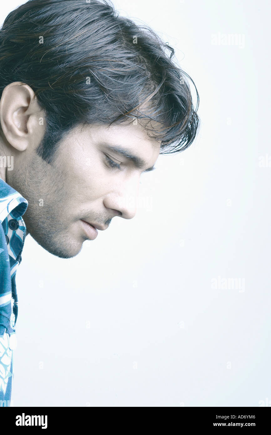 Side profile of a young man looking down Stock Photo - Alamy