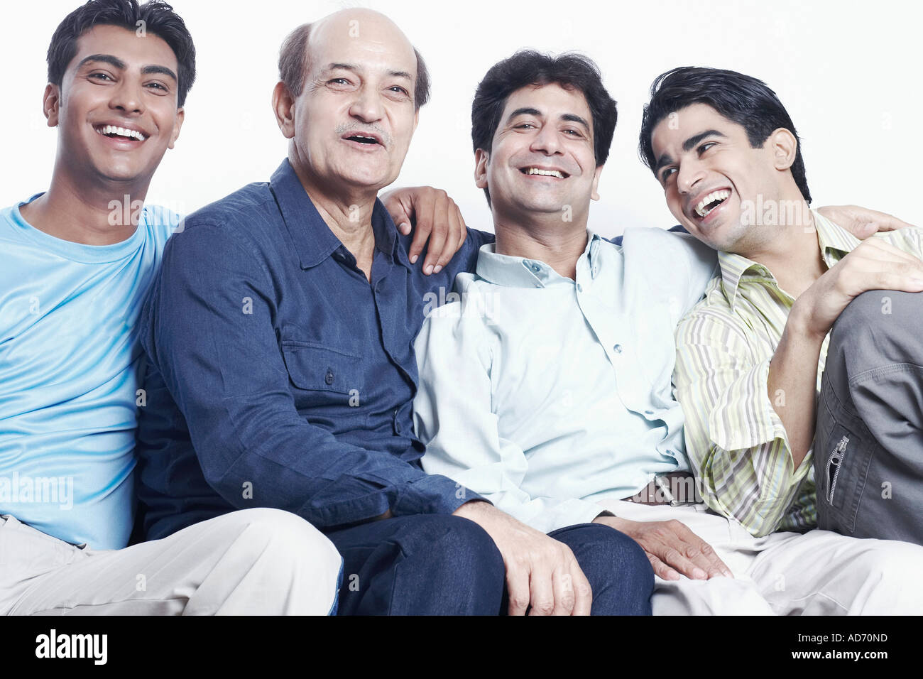 Portrait of a father sitting with his three sons Stock Photo - Alamy