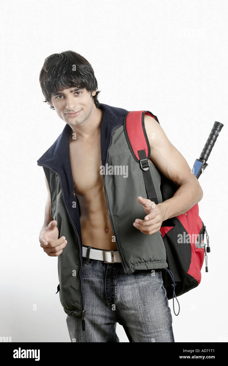 Portrait of a young man carrying a backpack Stock Photo - Alamy