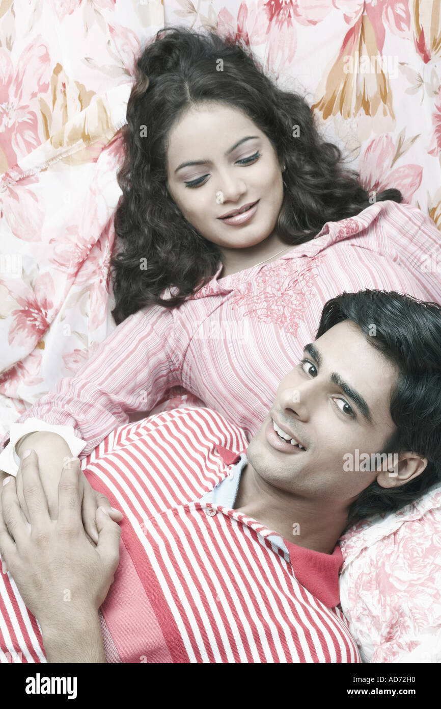 High angle view of a young couple lying down Stock Photo - Alamy