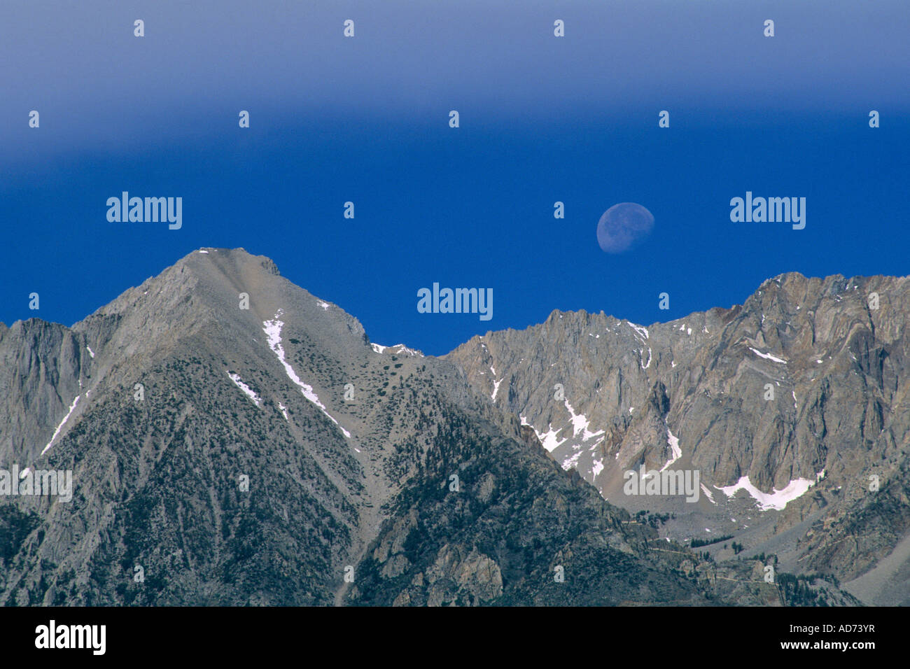 Moon sets over the crest of the Eastern Sierra near Independence Inyo ...