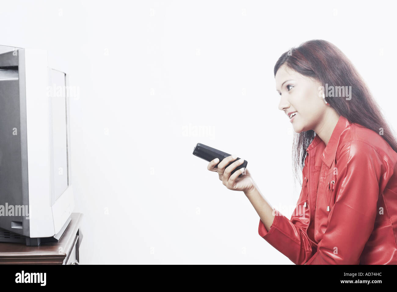 Side profile of a young woman watching television Stock Photo - Alamy