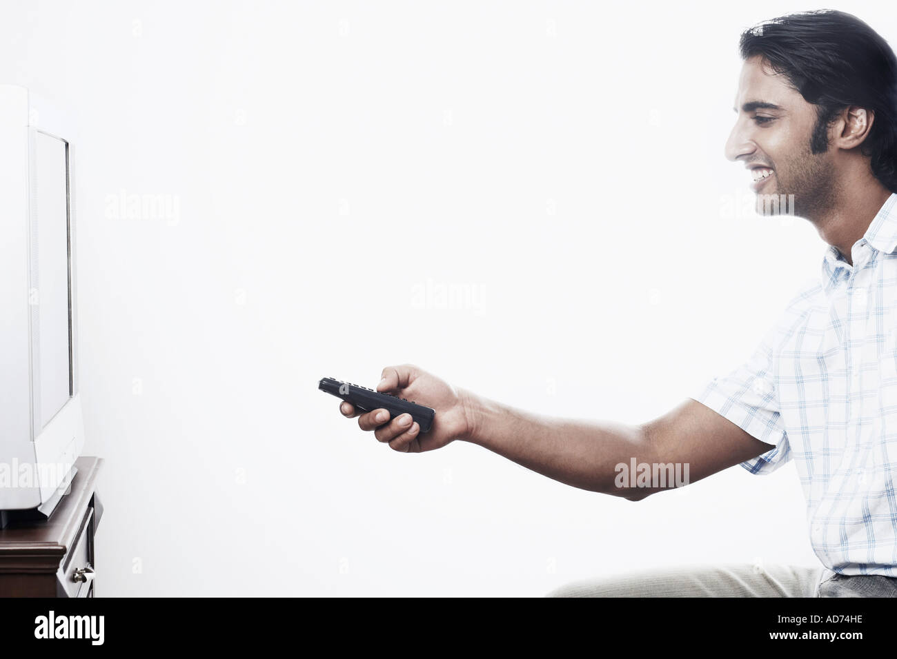 Side profile of a young man operating a remote control Stock Photo - Alamy