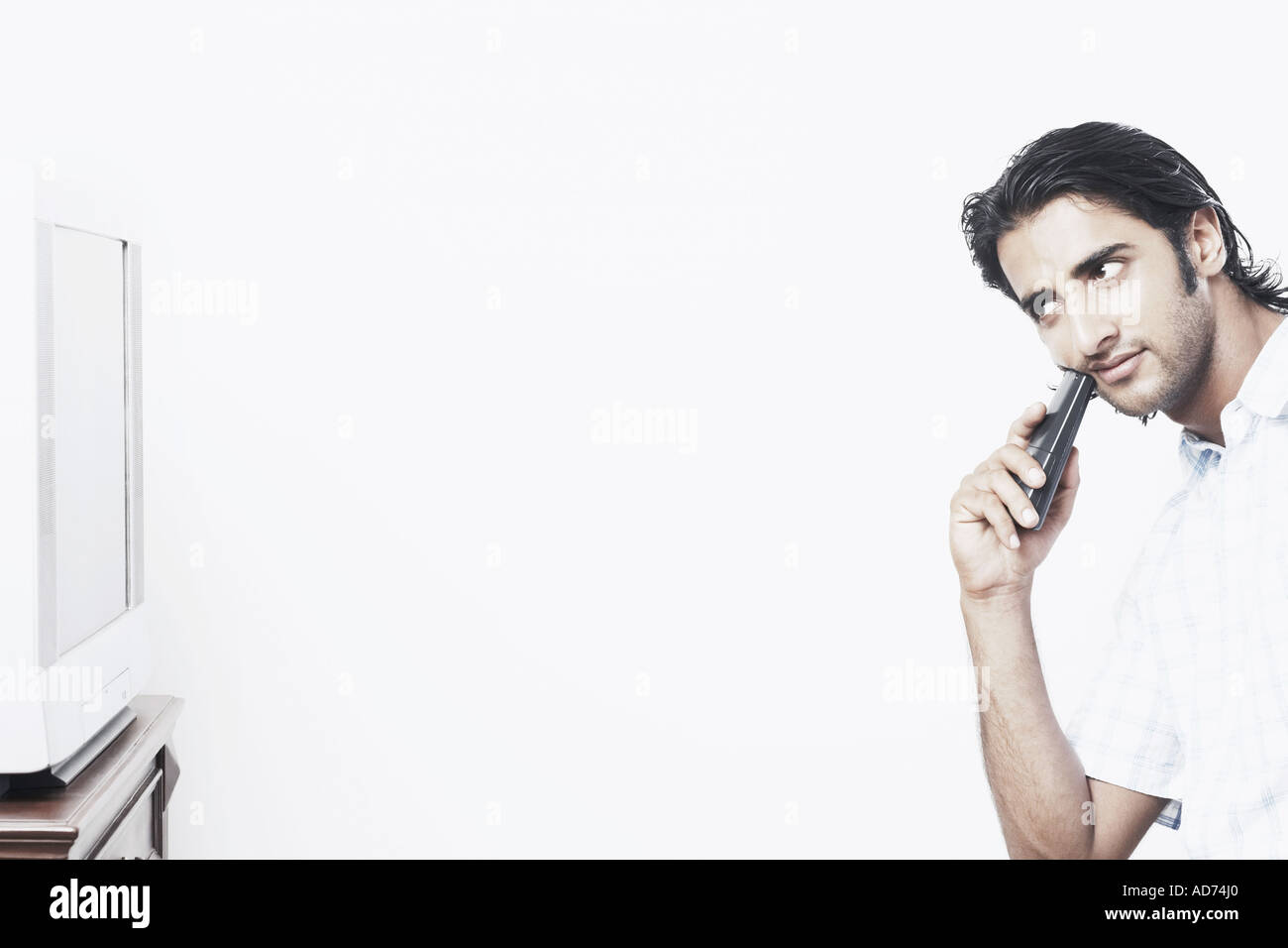 Side profile of a young man watching TV Stock Photo - Alamy