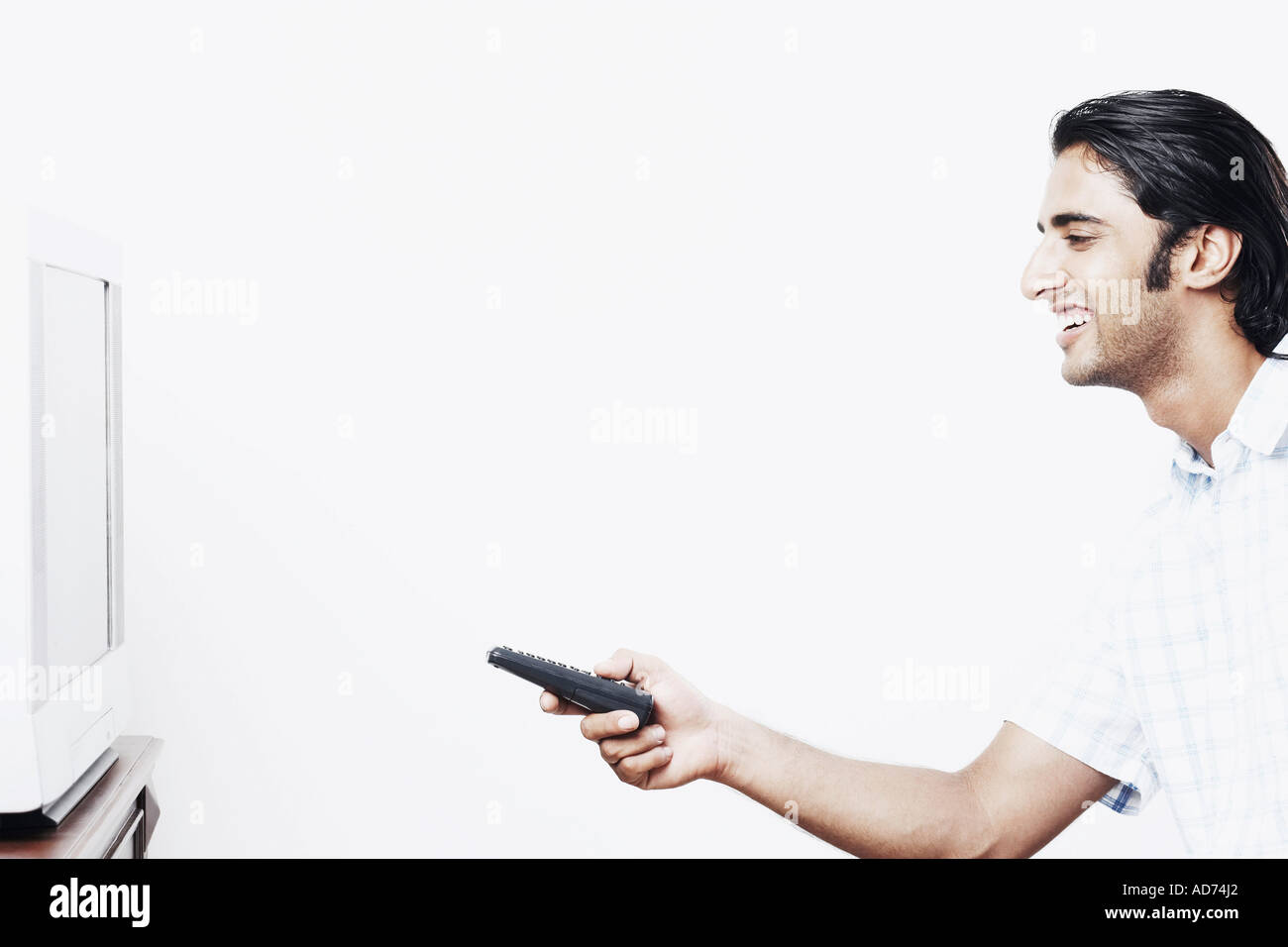 Side profile of a young man operating a remote control Stock Photo - Alamy