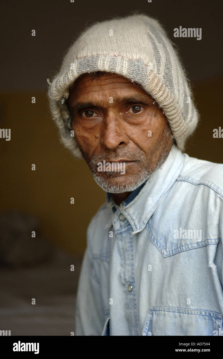 Portrait of a Nepalese man in denim shirt and knitted hat in Pokhara ...