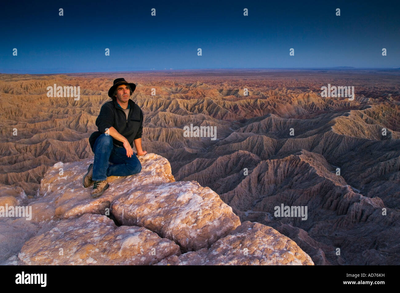 Tourist overlooking eroded hills of the Borrego Badlands Fonts Point ...