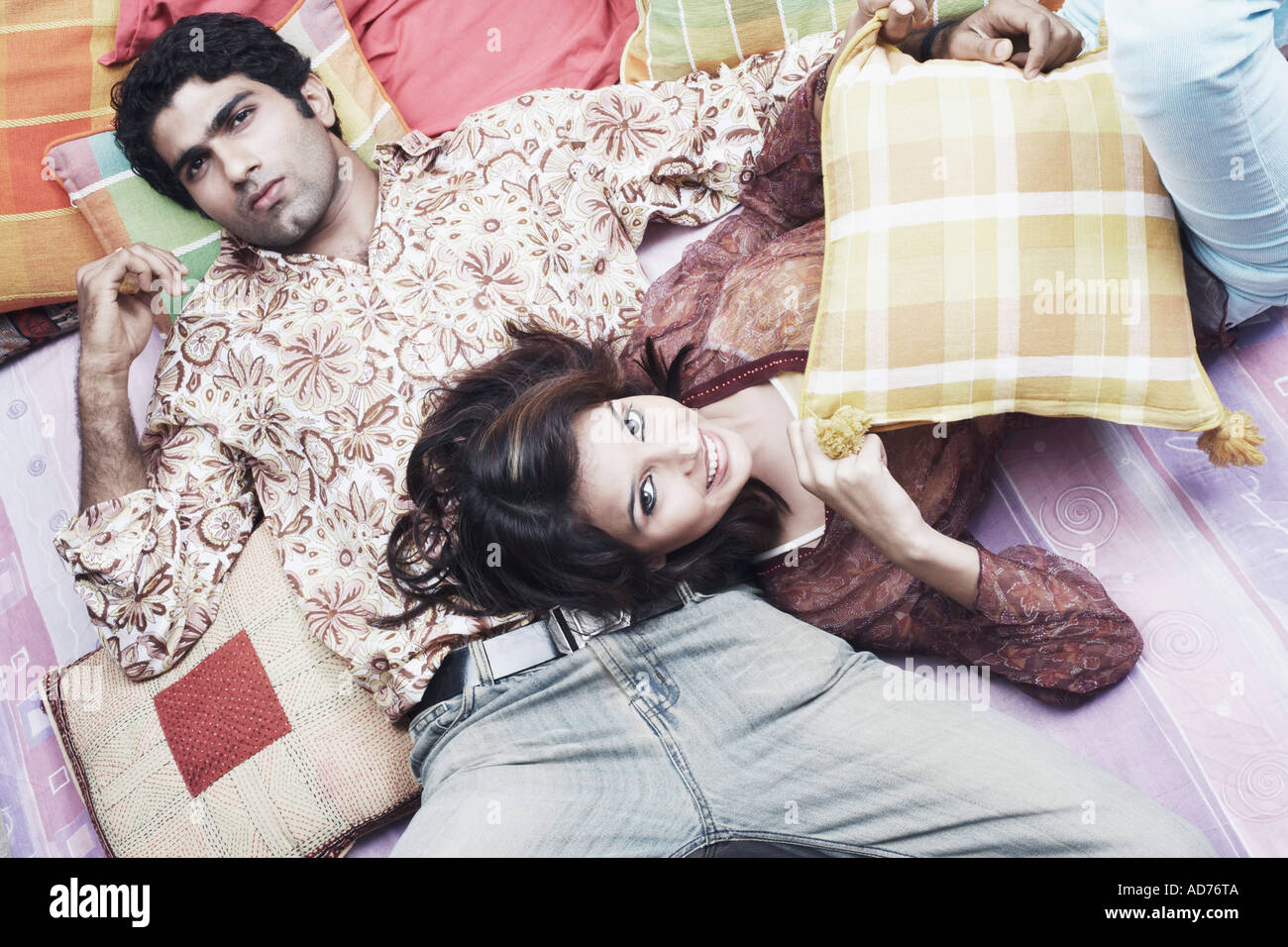 High angle view of a young woman lying on a young man's stomach Stock ...