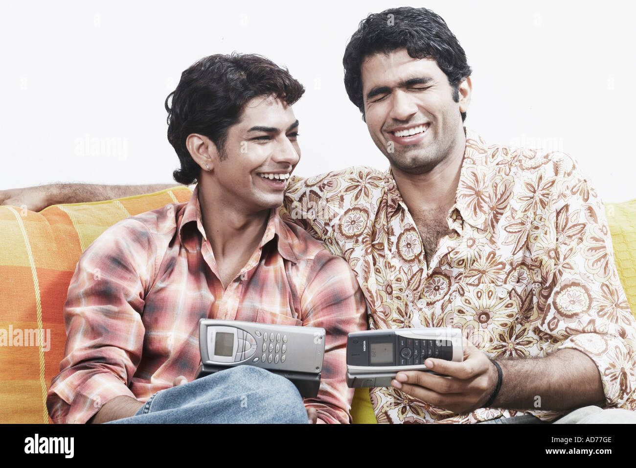 Young men holding mobile phones asian hi-res stock photography and ...