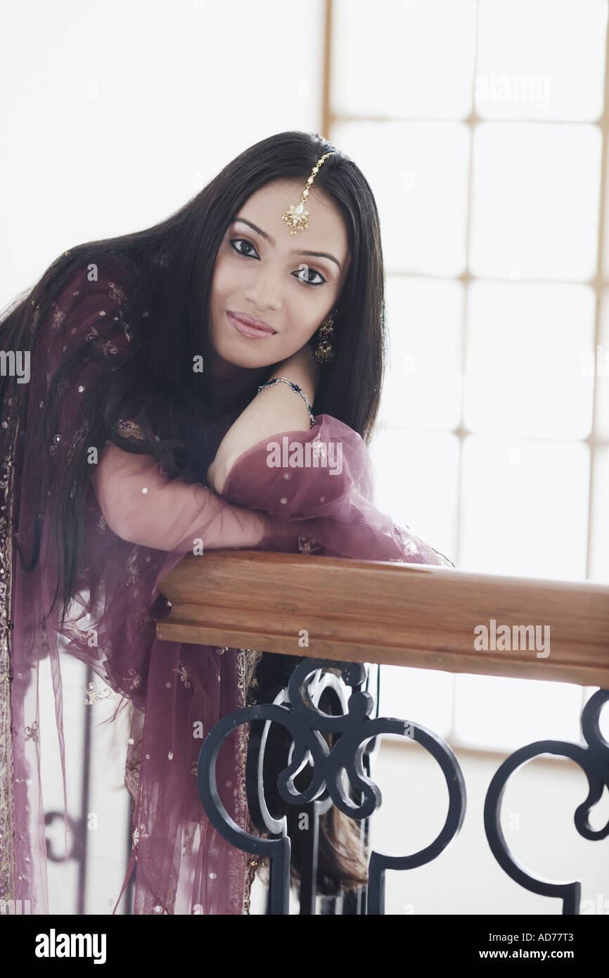 Portrait of a teenage girl leaning over a railing Stock Photo - Alamy