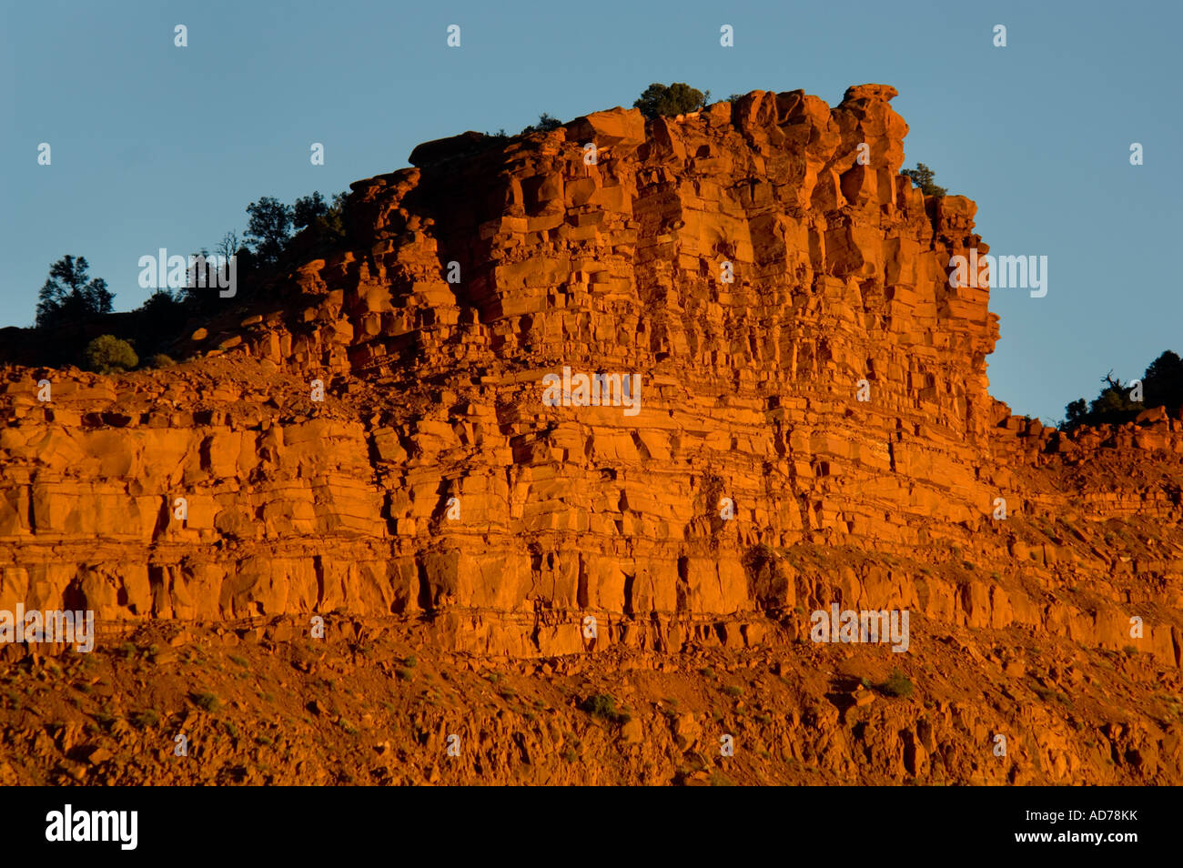 Sunset light on eroded hills and buttes along the Cockscomb Grand ...