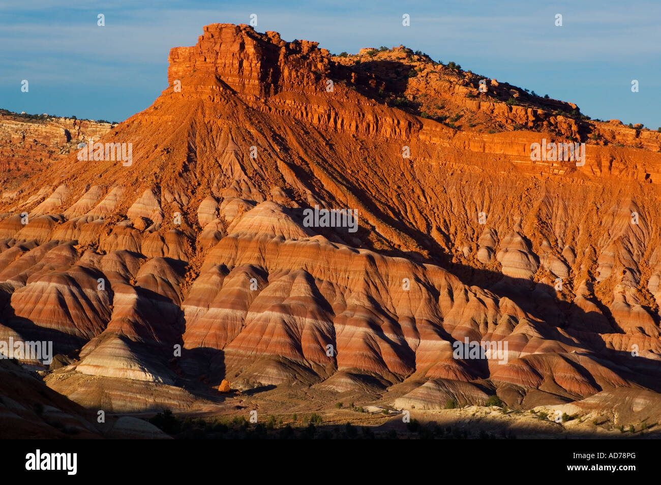 Sunset light on eroded hills and buttes along the Cockscomb Grand ...