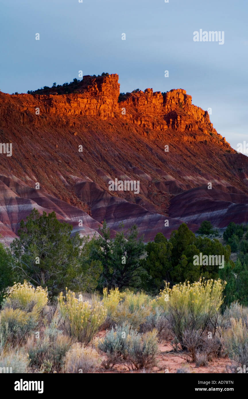 Sunset light on eroded hills and buttes along the Cockscomb Grand ...