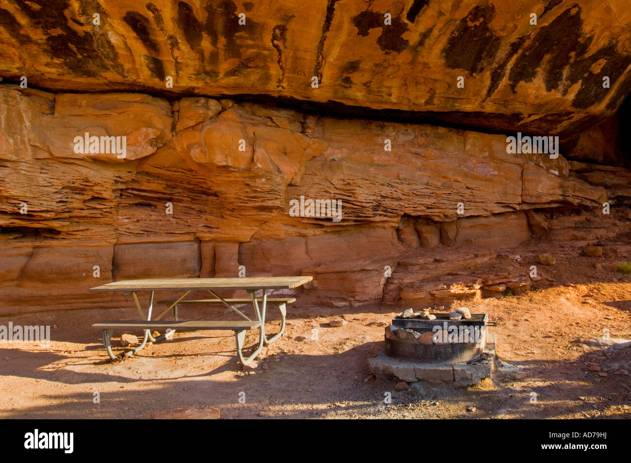 Picnic table fire pit and rock alcove at the Toroweap Campground ...