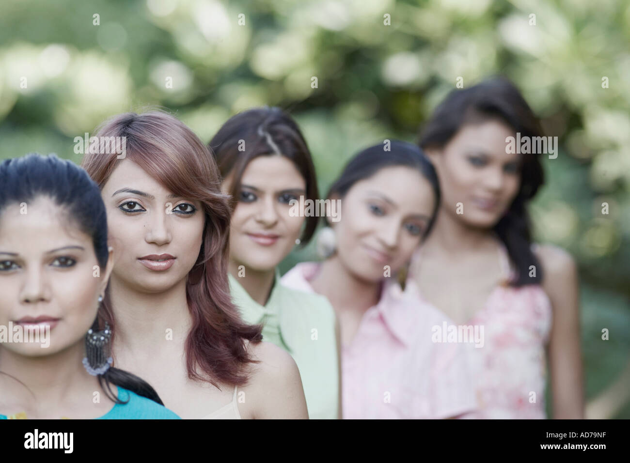 Five women standing in a row Stock Photo - Alamy