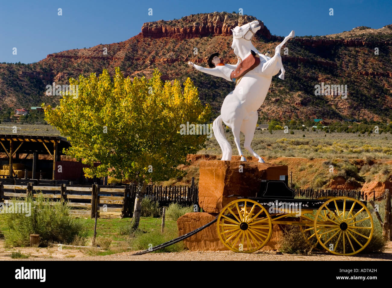 Horse and cowboy rider statue and old wagon on display at old western ...