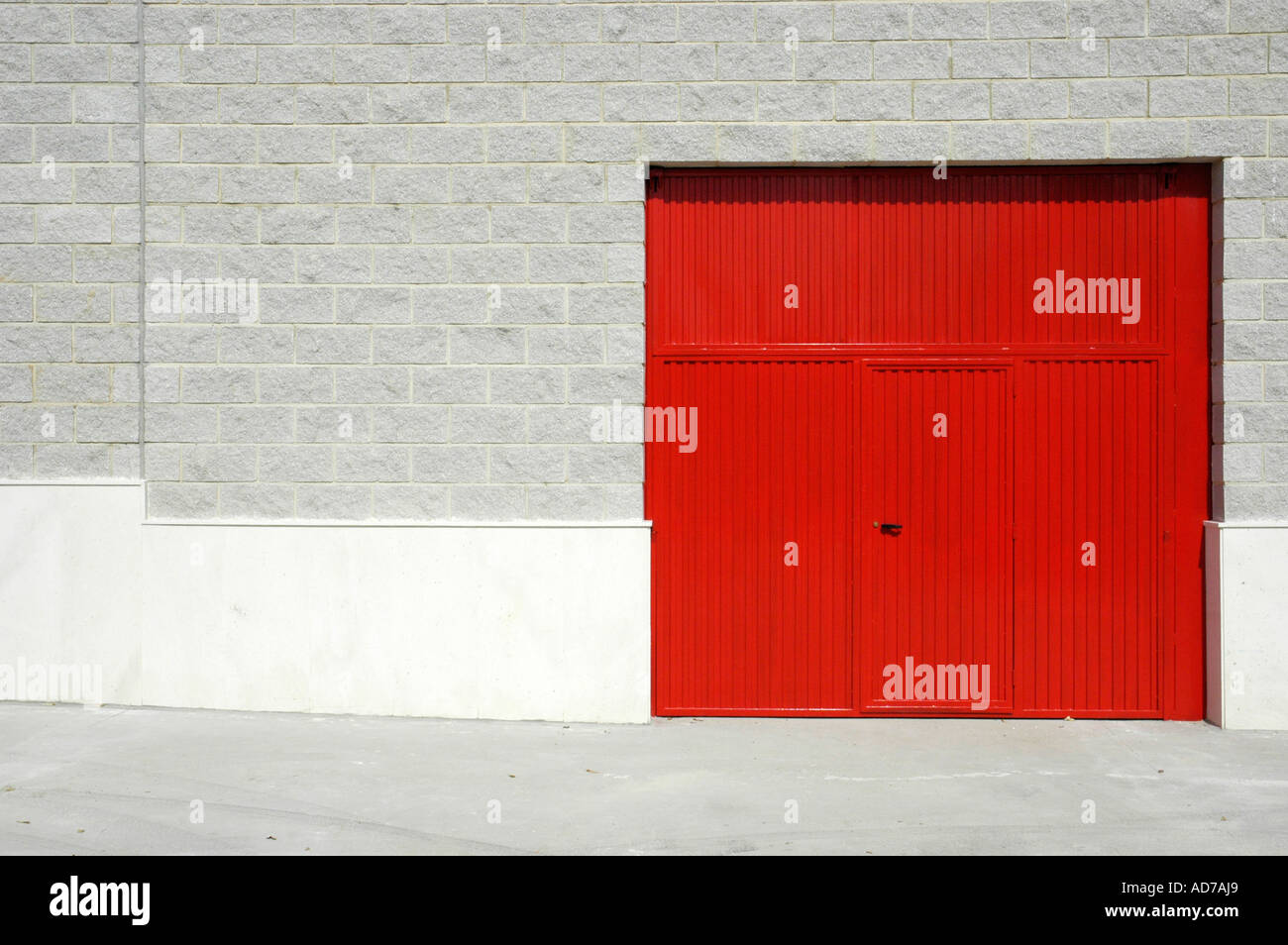 Large red door in white house wall Stock Photo - Alamy