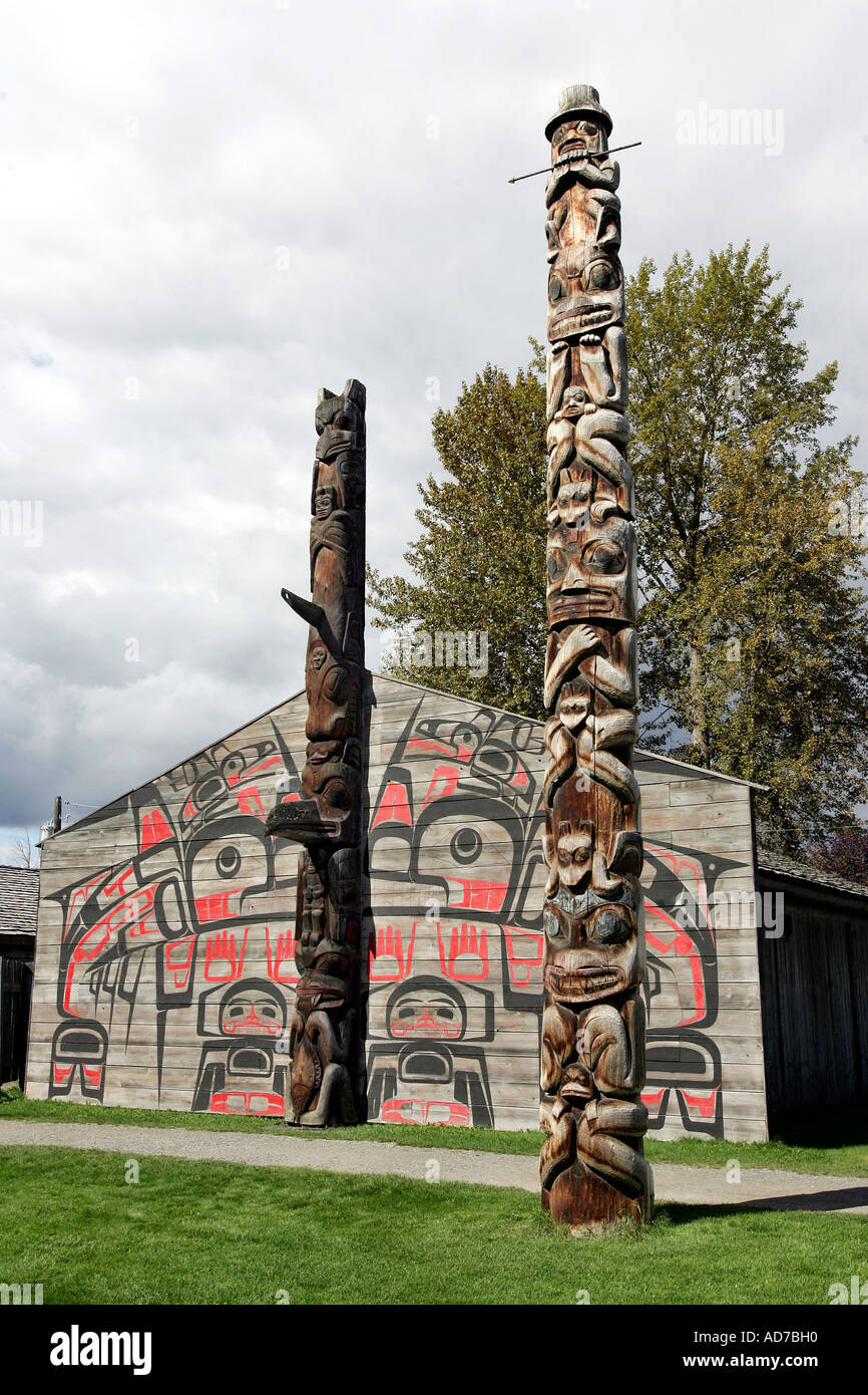 Totem pole in front of long houses at Ksan Historical Village, British ...