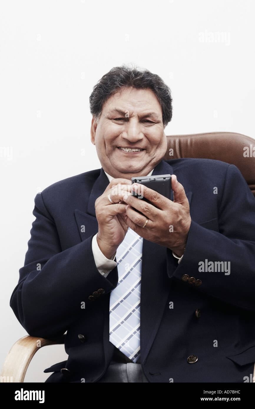 Portrait of a businessman operating a personal data assistant Stock ...