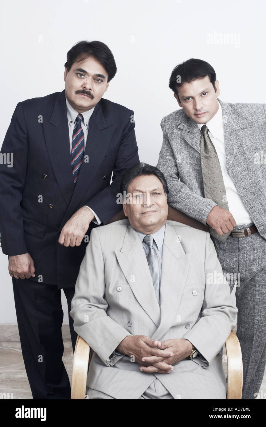 Portrait of a father and his two sons posing Stock Photo - Alamy