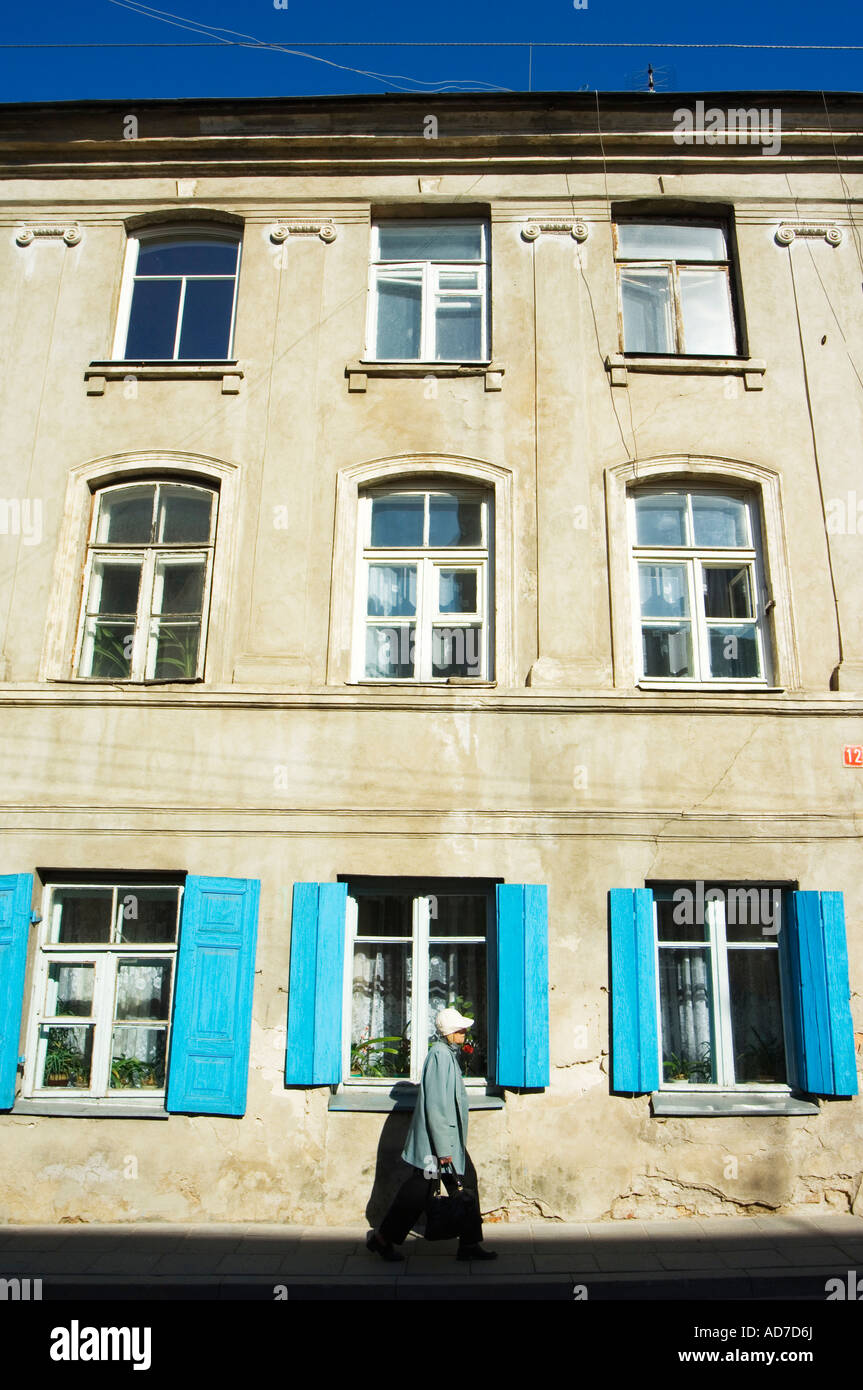 Lithuania Baltic States Vilnius A Woman walking past Colourful Windows ...