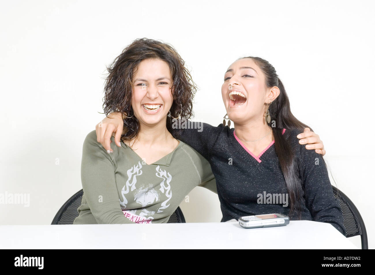 Portrait of two young women with their arms around each other Stock ...
