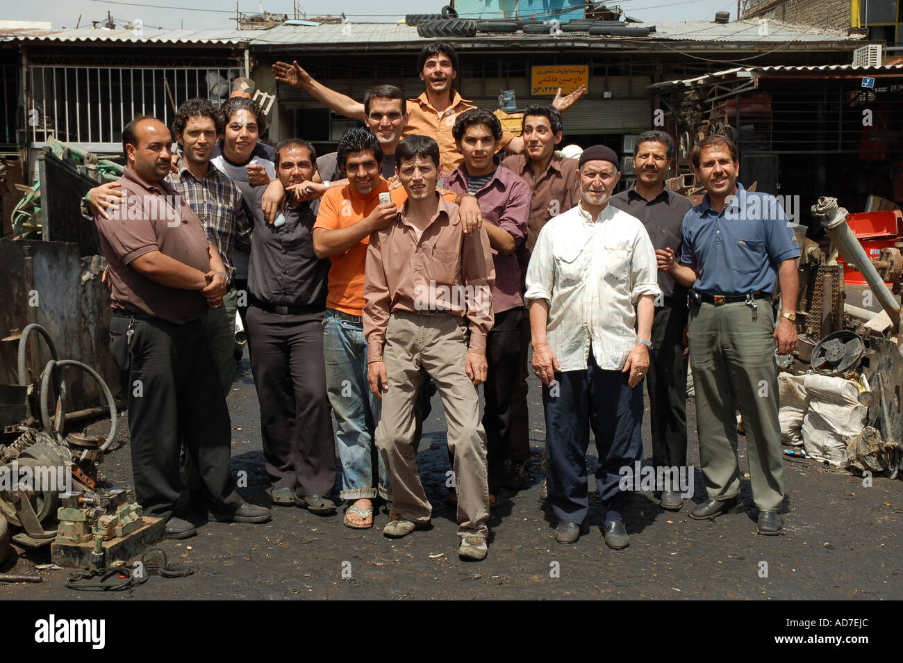Happy Scrap yard workers posing for the camera in Shoosh, down town ...