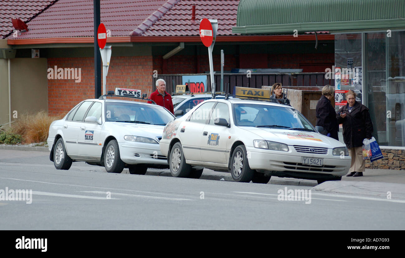 Two taxis parked at kerbside Stock Photo - Alamy