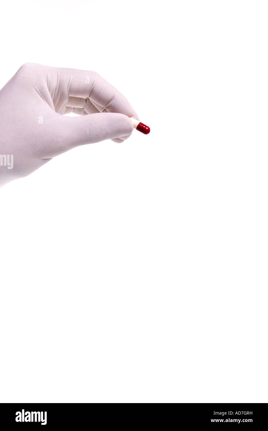 Gloved hand giving pill Stock Photo - Alamy