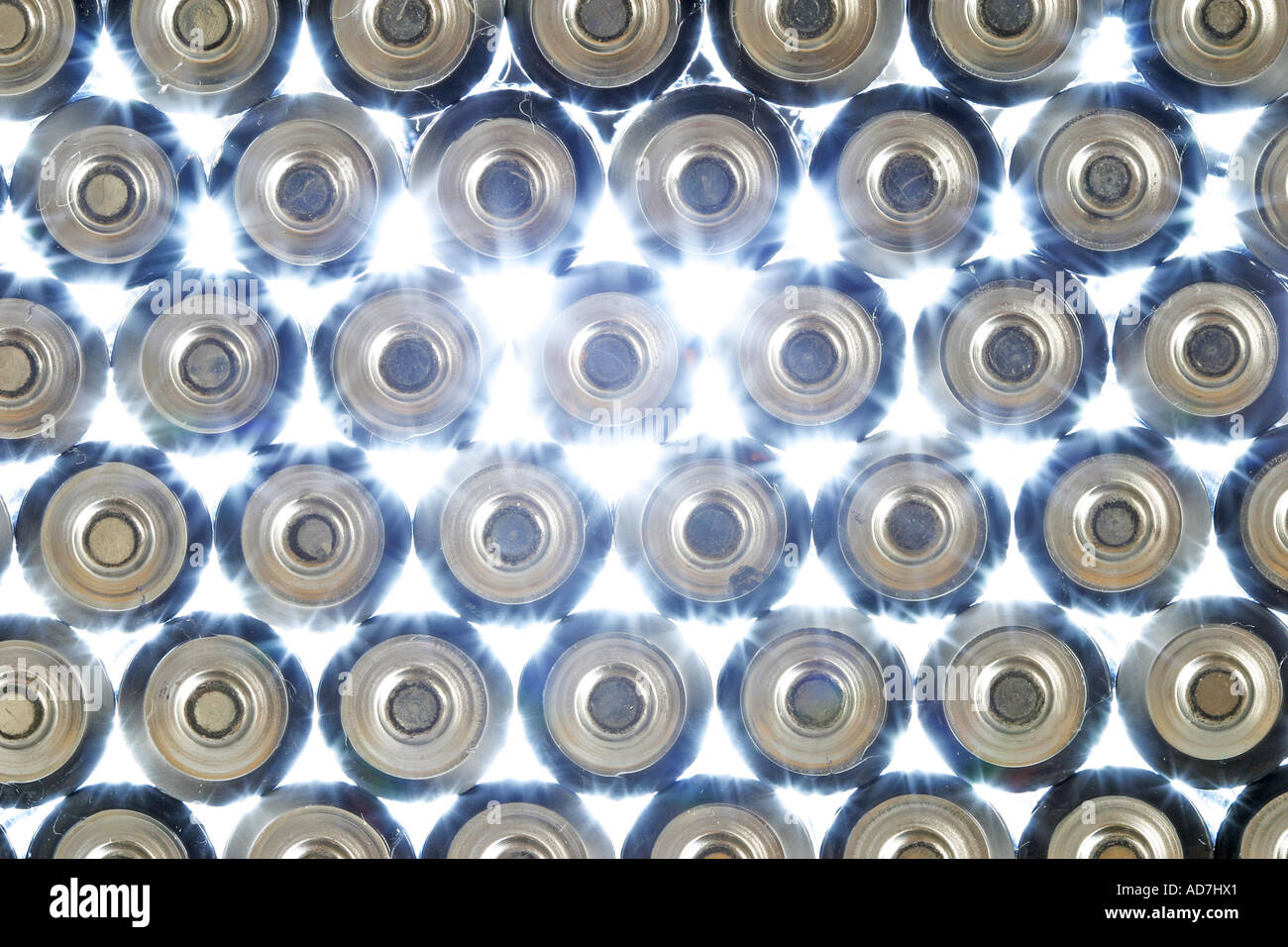 Batch of batteries in backlight symbol of energy Stock Photo - Alamy