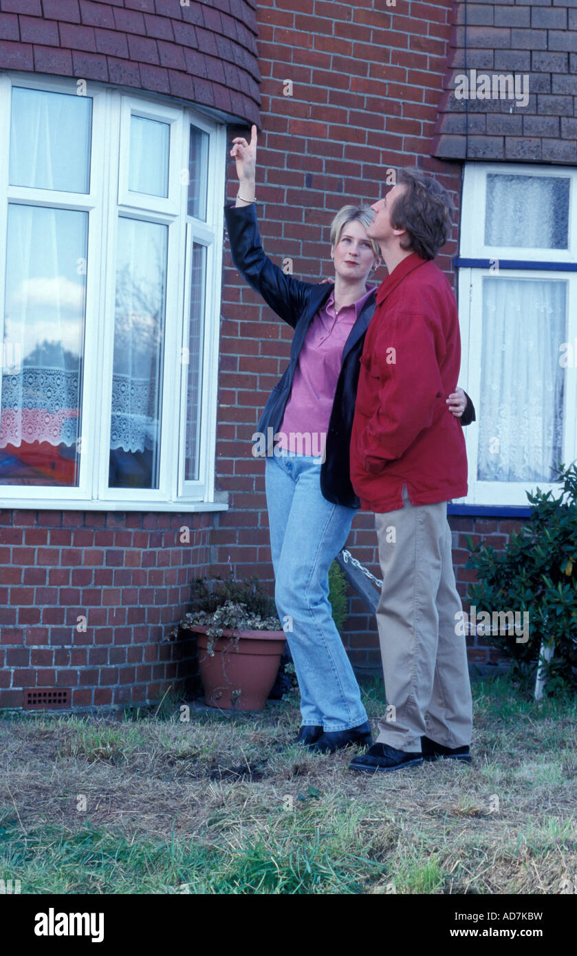 young couple viewing house from the outside Stock Photo - Alamy