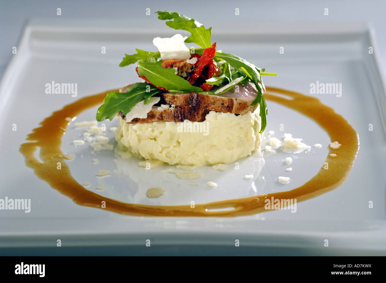 Roast pork on a bed of champ with a rocket salad garnish Stock Photo ...